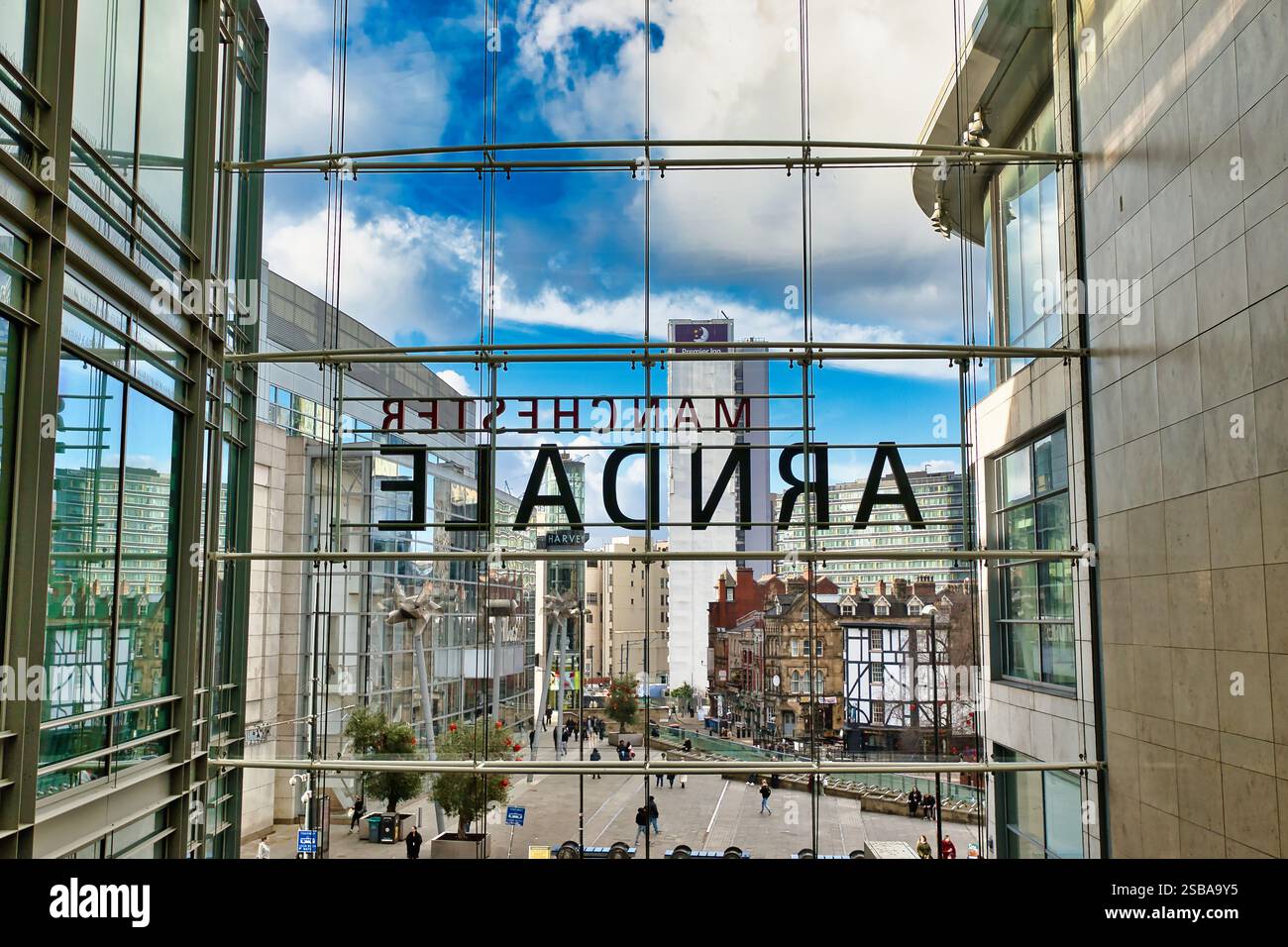 View through a glass-walled arcade in Manchester, showcasing the ...