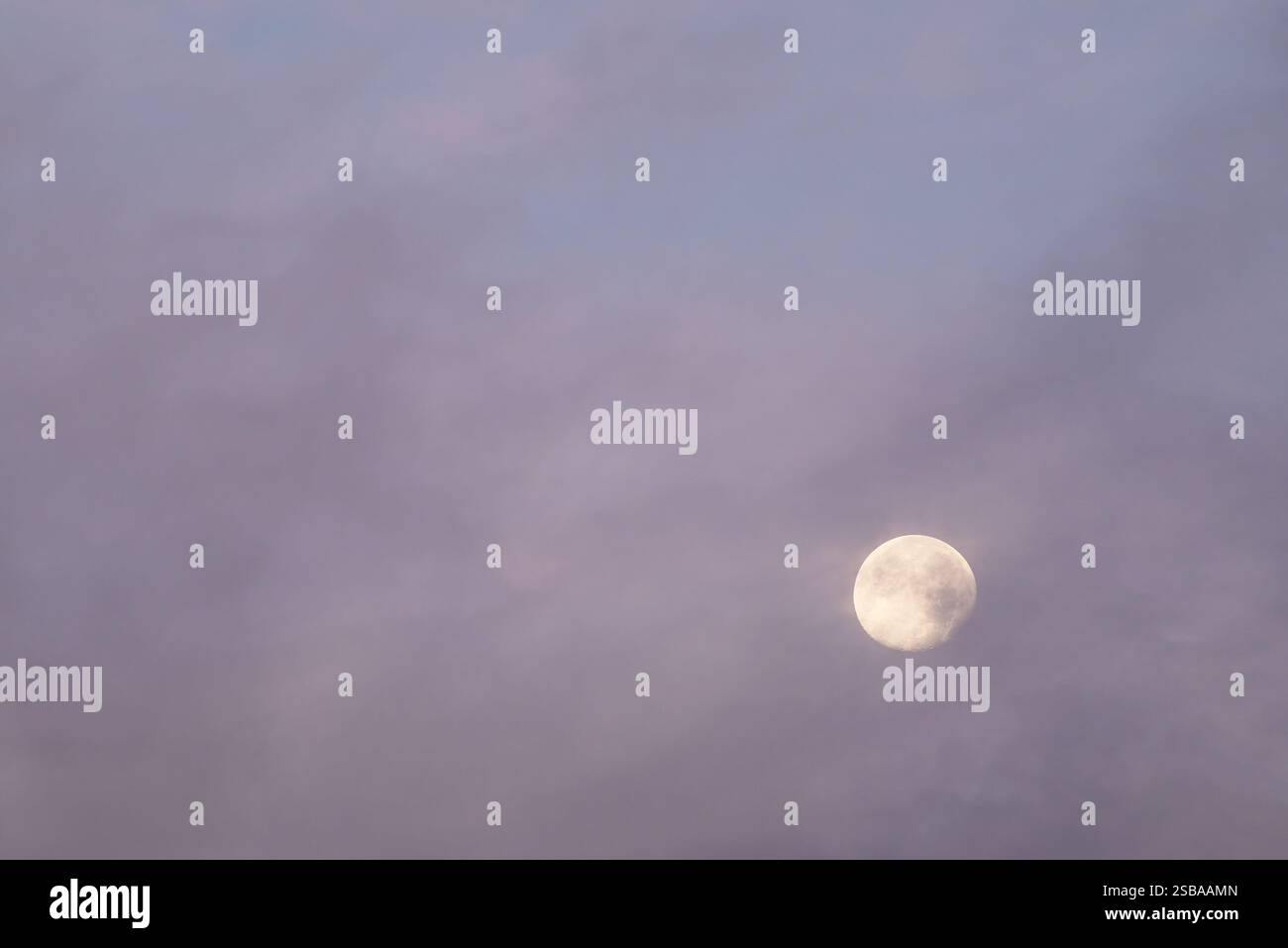 Full moon through clouds and fog in a gray sky Stock Photo - Alamy