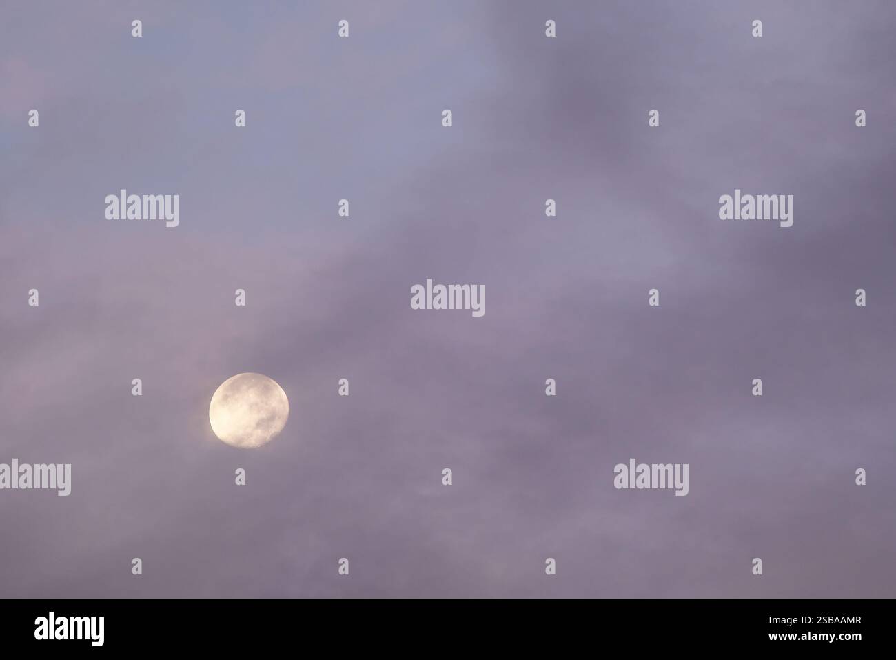 Full moon through clouds and fog in a gray sky Stock Photo - Alamy