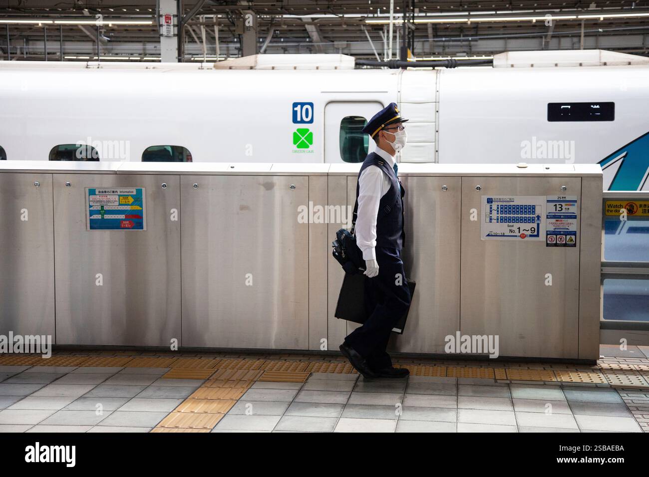 OSAKA, JAPAN: A Shinkansen N700 bullet train at Shin-Osaka train station with a station staff on ...