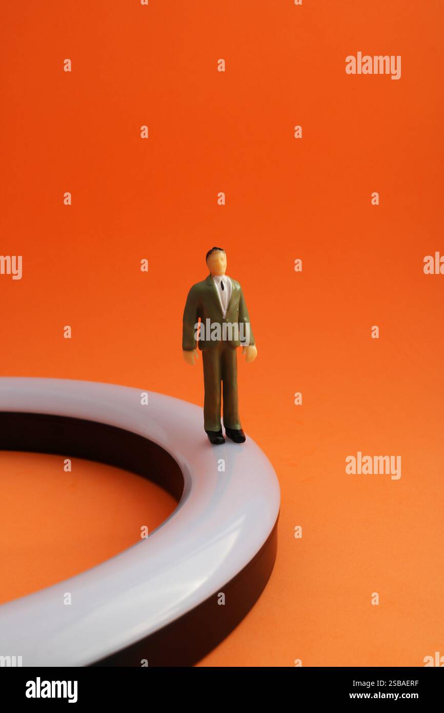 Executive walking along circular path - vertical format Stock Photo - Alamy