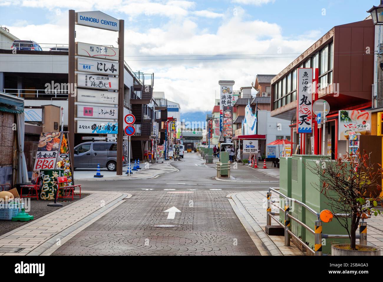 A winding street in Numazu Port lined with seafood restaurants and ...
