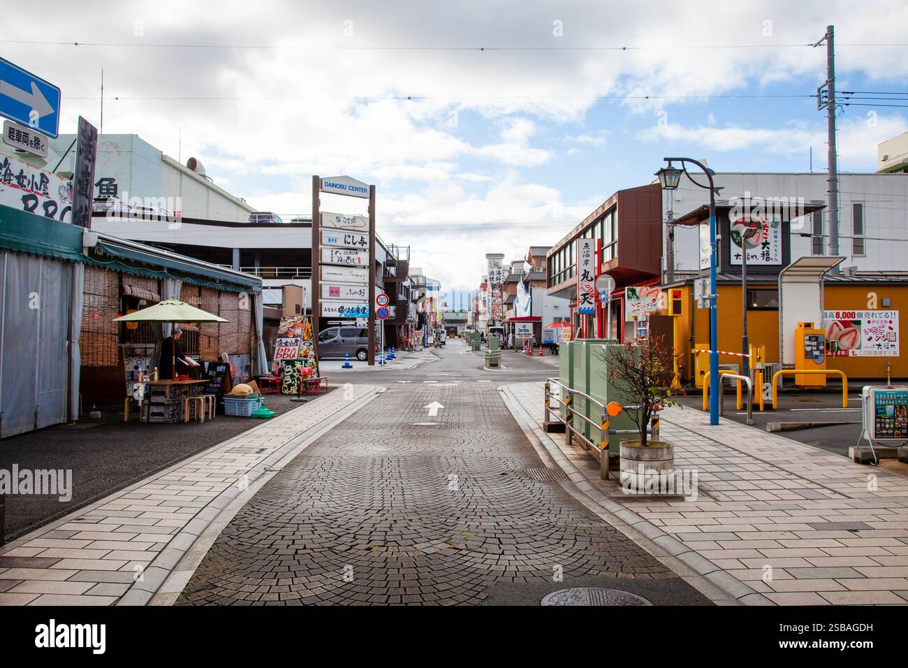 A winding street in Numazu Port lined with seafood restaurants and ...