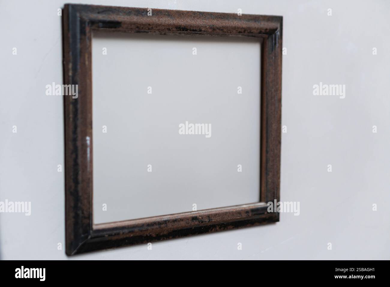 An empty, vintage-style picture frame with a distressed black finish ...