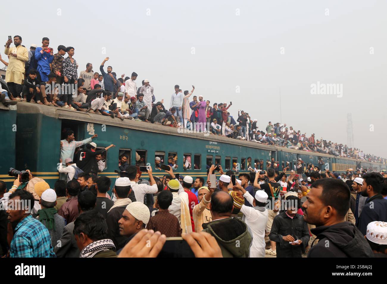 Dhaka. 2nd Feb, 2025. Devotees climb on an overcrowded train to return ...