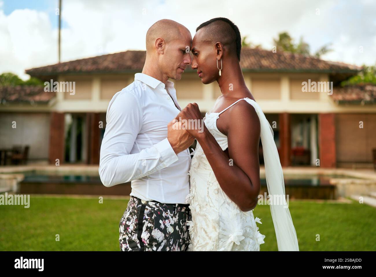 Ambiguous gender fluid person in bridal dress, lgbtq groom in bold suit ...