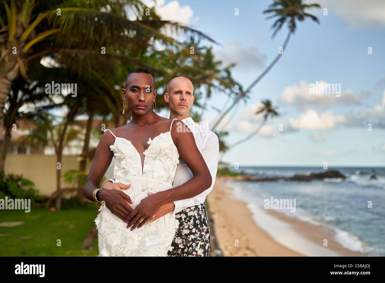 Ambiguous gender fluid person in white wedding dress with lgbtq partner ...