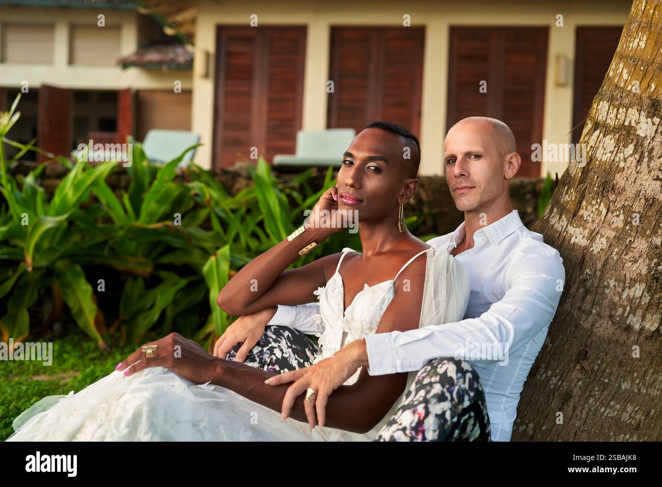Ambiguous gender fluid person in bride dress with LGBTQ groom in bold ...