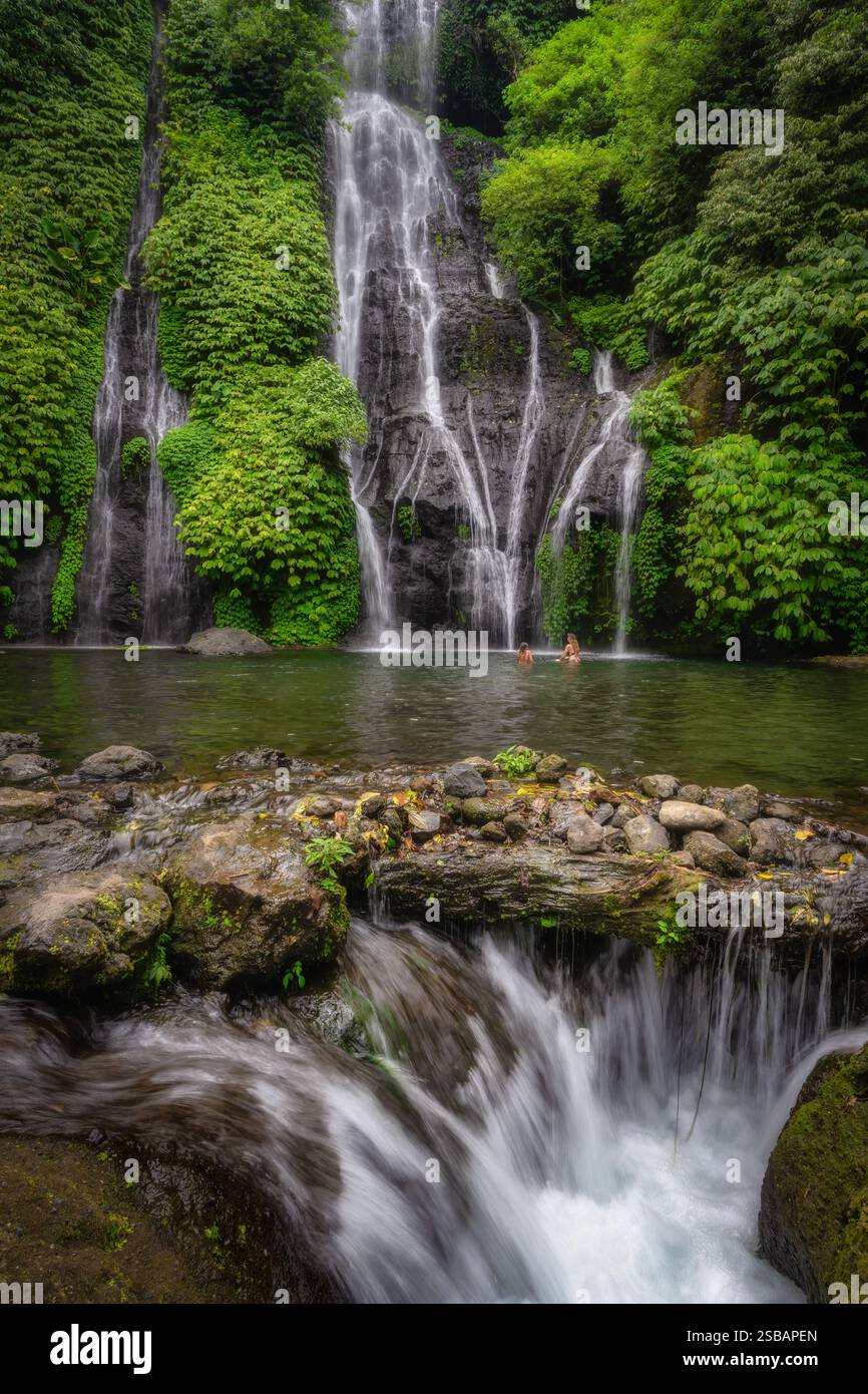 A breathtaking Banyumala Twin Waterfalls, enveloped by lush, vibrant ...