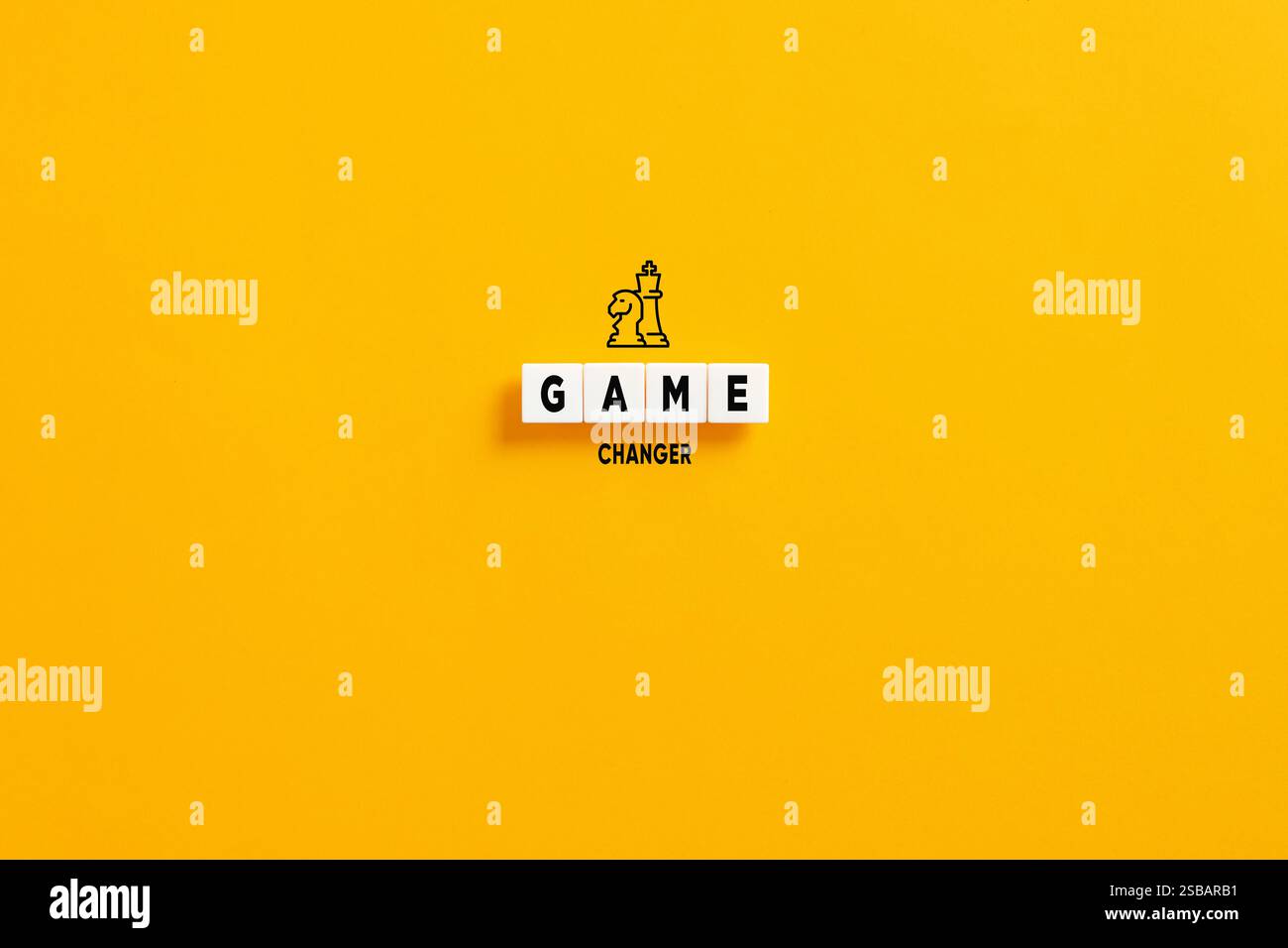 White letter blocks on yellow background with the word game changer ...
