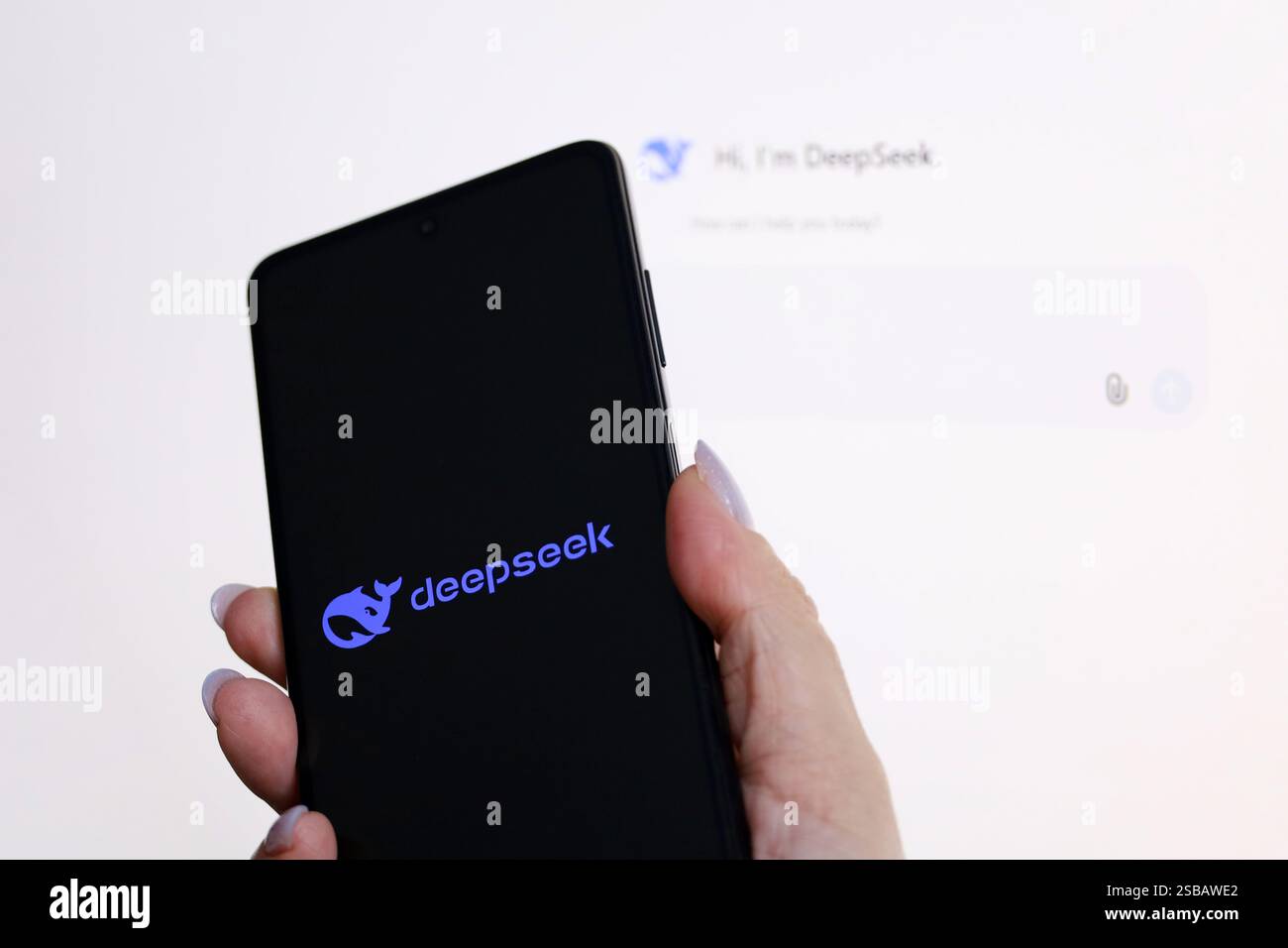 Deep Seek Ai logo on computer display and smartphone screen in a female ...