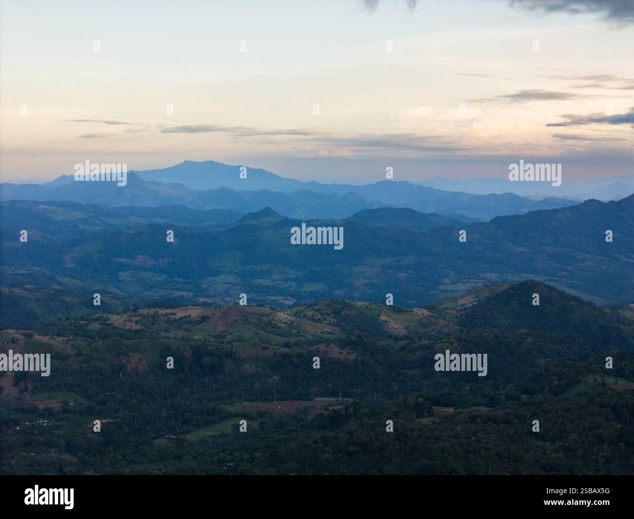 Expansive landscape showcases layered mountains during dusk, revealing ...