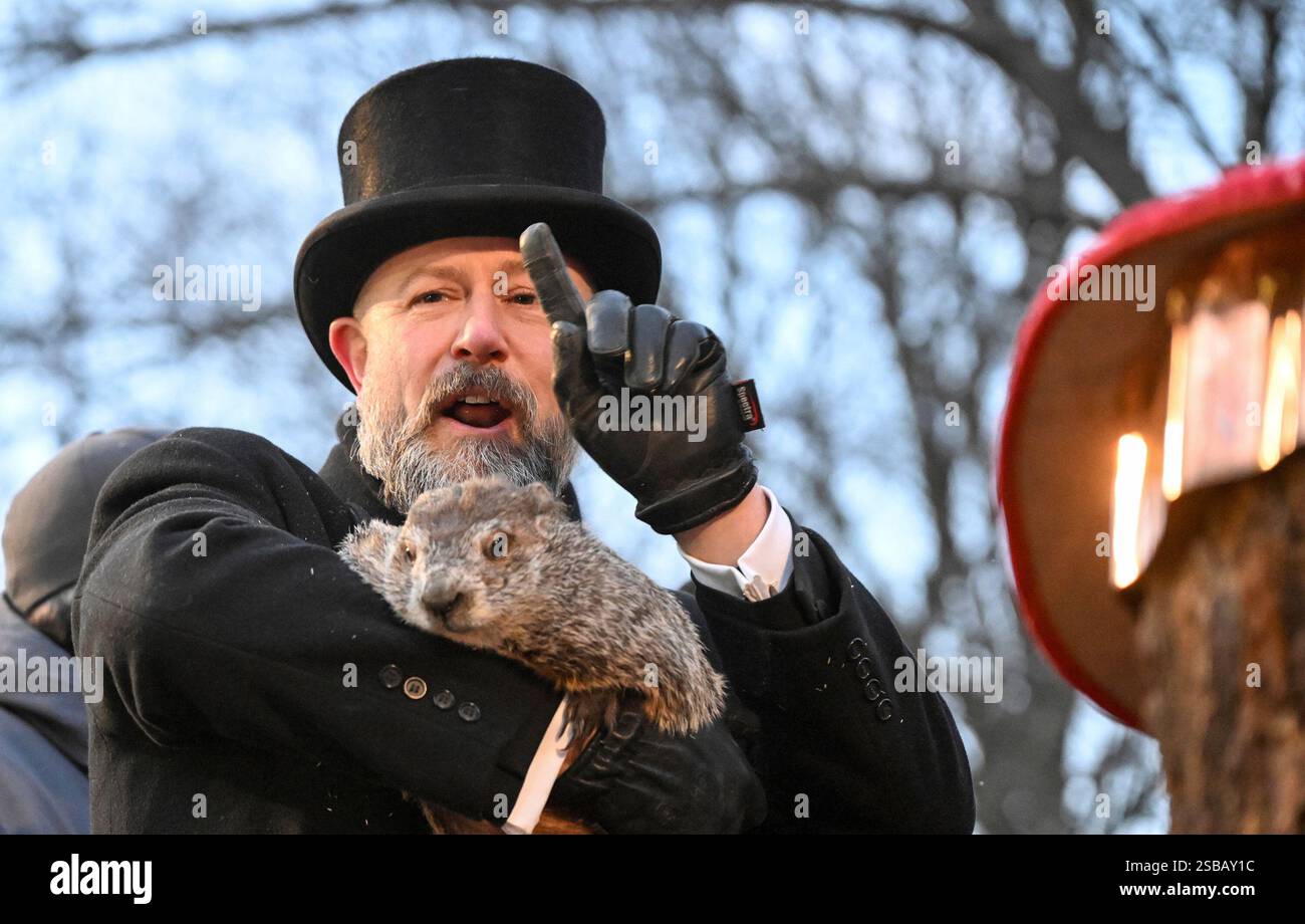 Groundhog Club handler A.J. Dereume holds Punxsutawney Phil, the ...