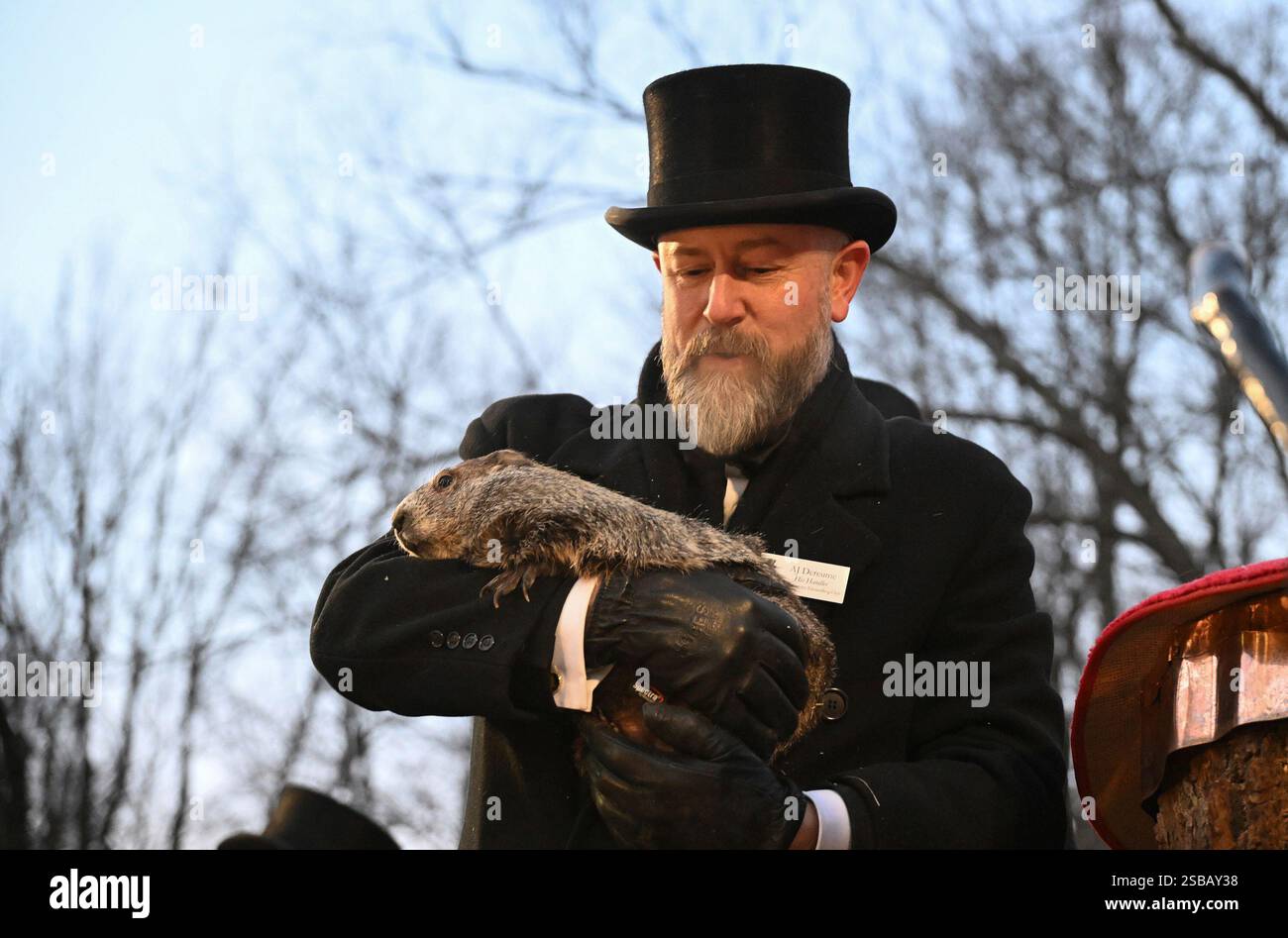 Groundhog Club handler A.J. Dereume holds Punxsutawney Phil, the ...