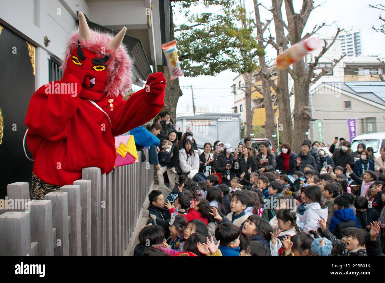 Tokyo, Japan. 02nd Feb, 2025. People dressed a demon throw beans during ...