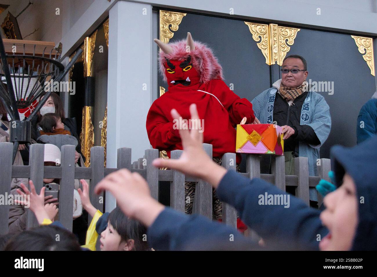 Tokyo, Japan. 02nd Feb, 2025. People dressed a demon throw beans during ...