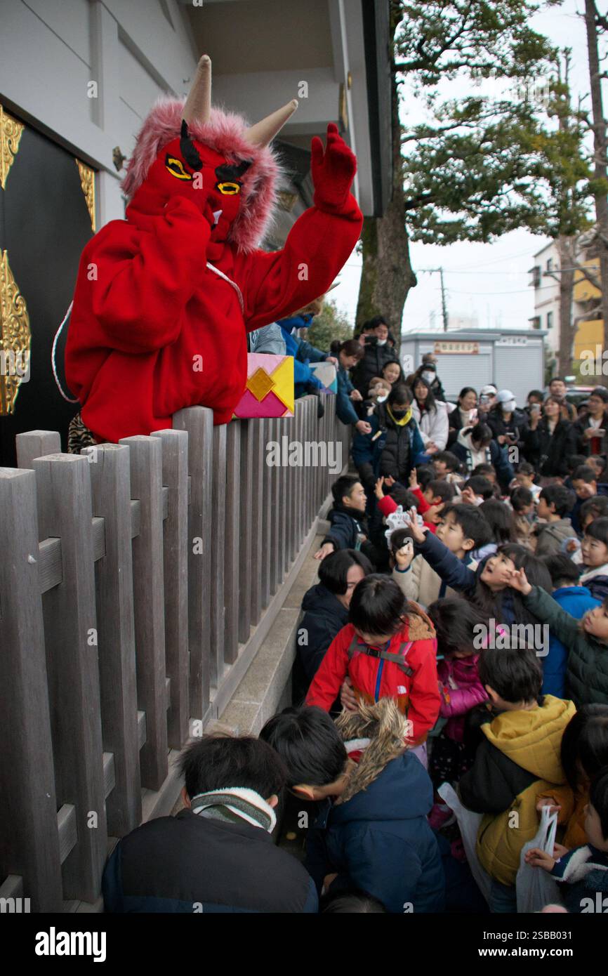 Tokyo, Japan. 02nd Feb, 2025. People dressed a demon throw beans during ...