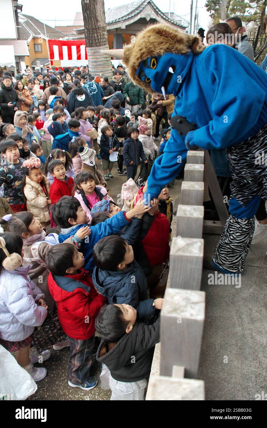 Tokyo, Japan. 02nd Feb, 2025. People dressed a demon shaks hands with ...