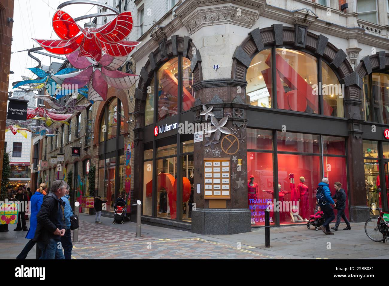 Street view along a colourful high street with on-trend store window of ...