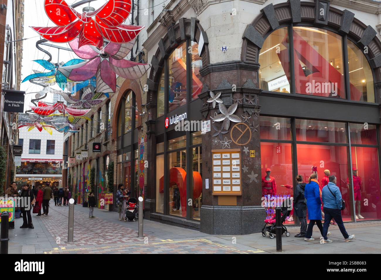 Street view along a colourful high street with on-trend store window of ...