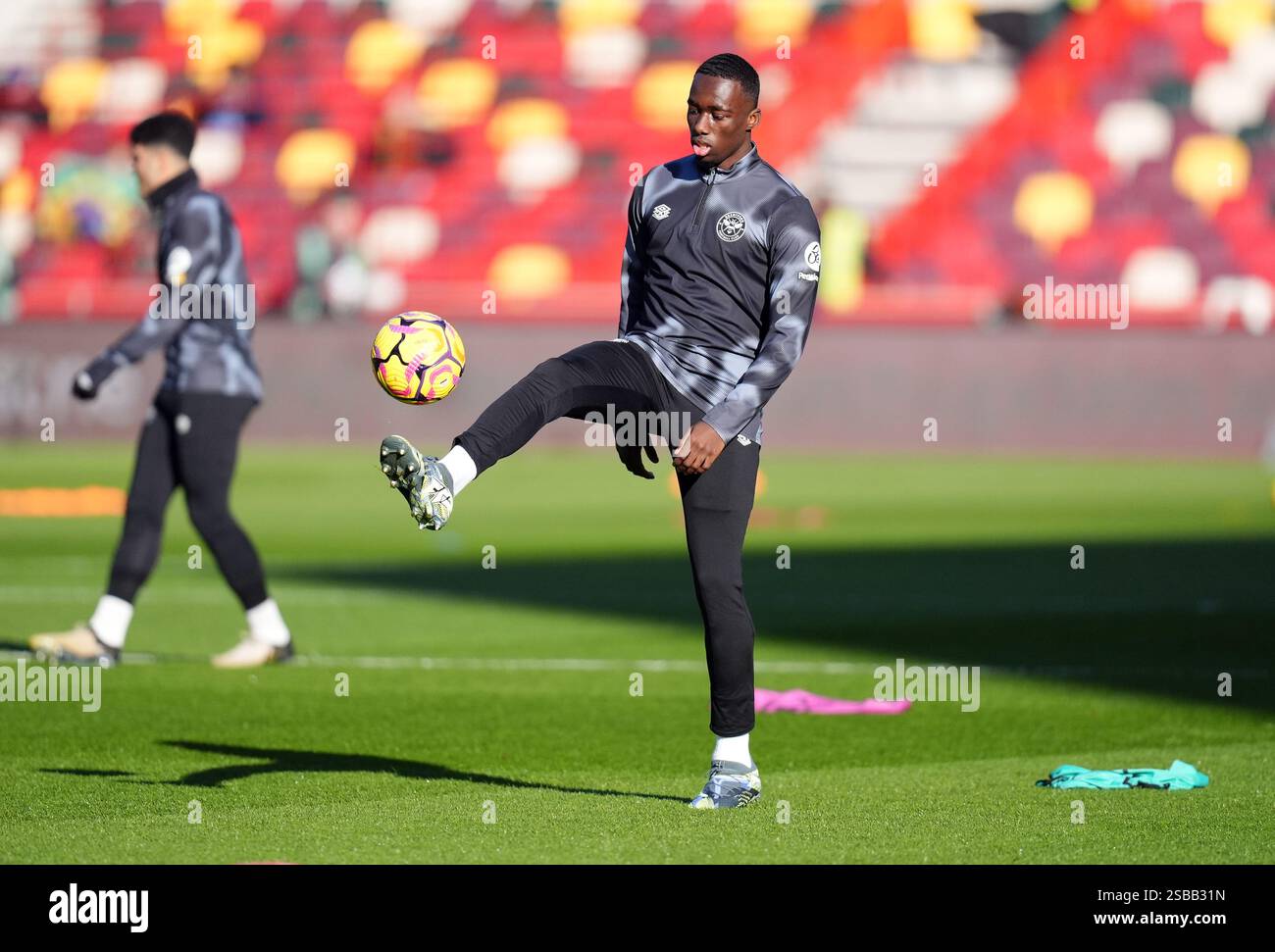 Brentford's Michael Kayode warms up before the Premier League match at ...