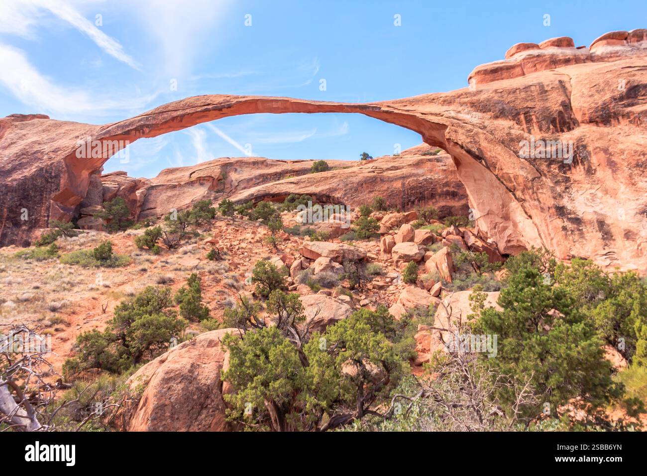 A bridge spans a canyon with a clear blue sky above. The bridge is ...