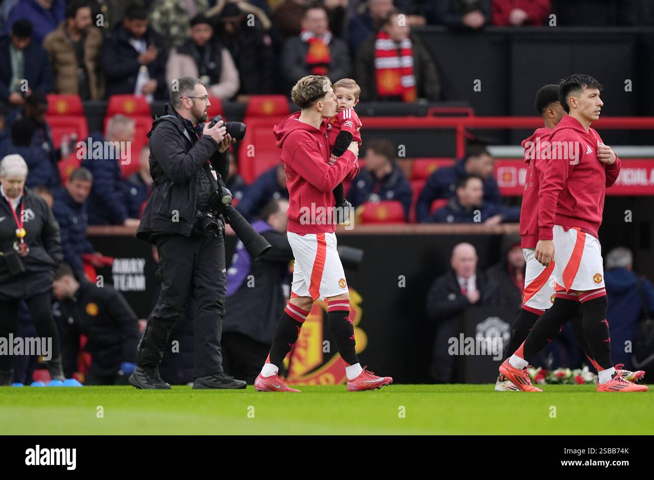 Manchester United's Alejandro Garnacho (left) walks onto the pitch with ...