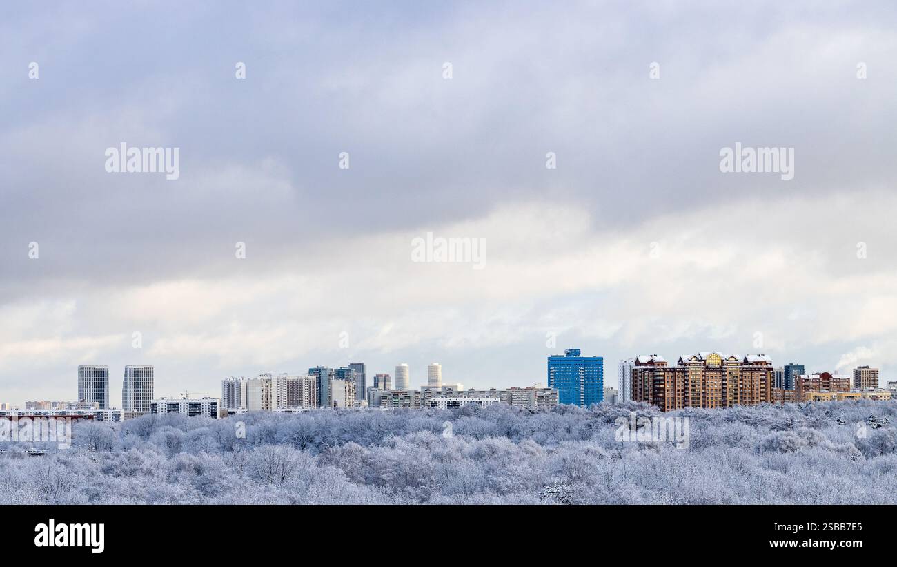 low snow clouds over town and city park after snowing in winter day ...