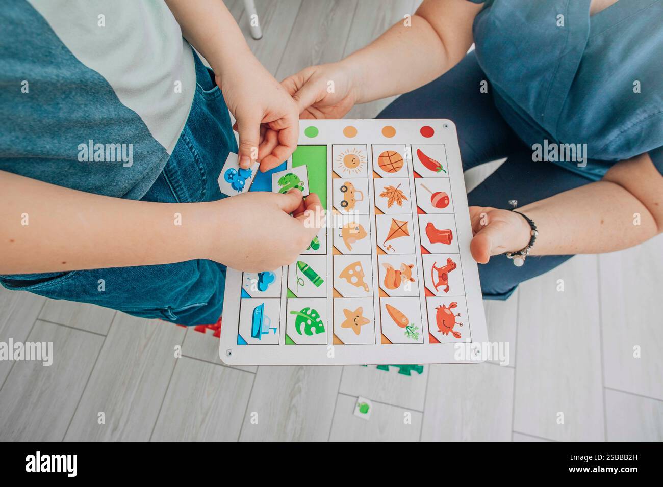 child engaging in color-matching on educational board in structured ...