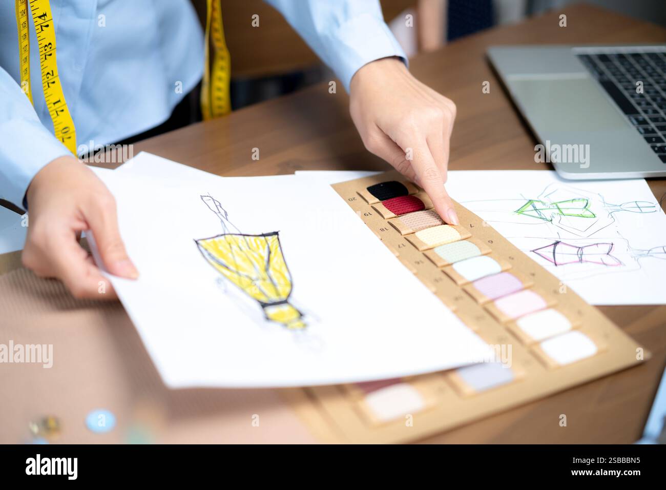 A female designer is creating clothing designs in her studio Stock ...