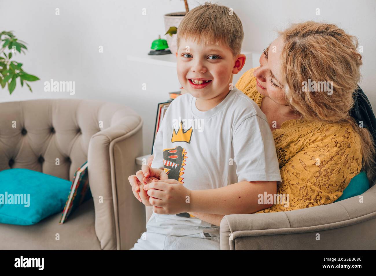female therapist and boy practicing hand gestures in therapy session ...