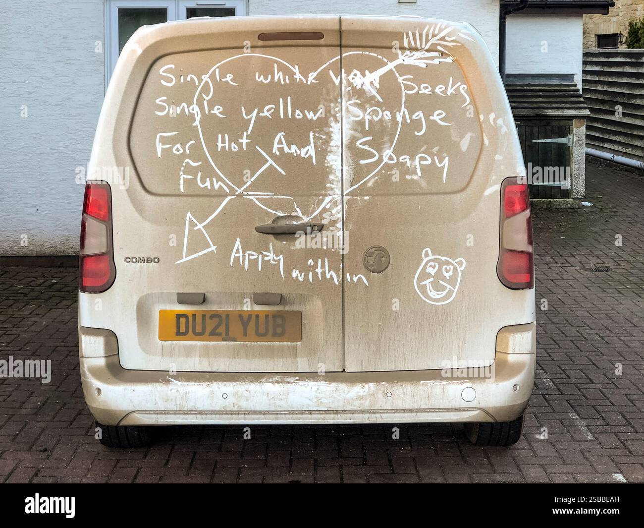 Graffiti written in the dirt on the rear doors of a very dirty white van (UK Stock Photo - Alamy