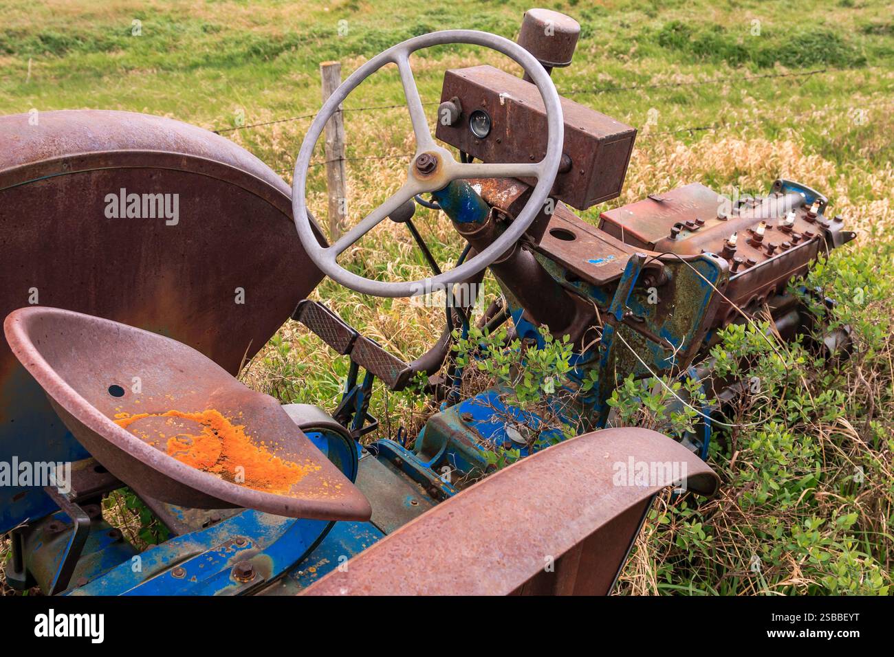 An old, rusted tractor with a worn out steering wheel. The tractor is ...