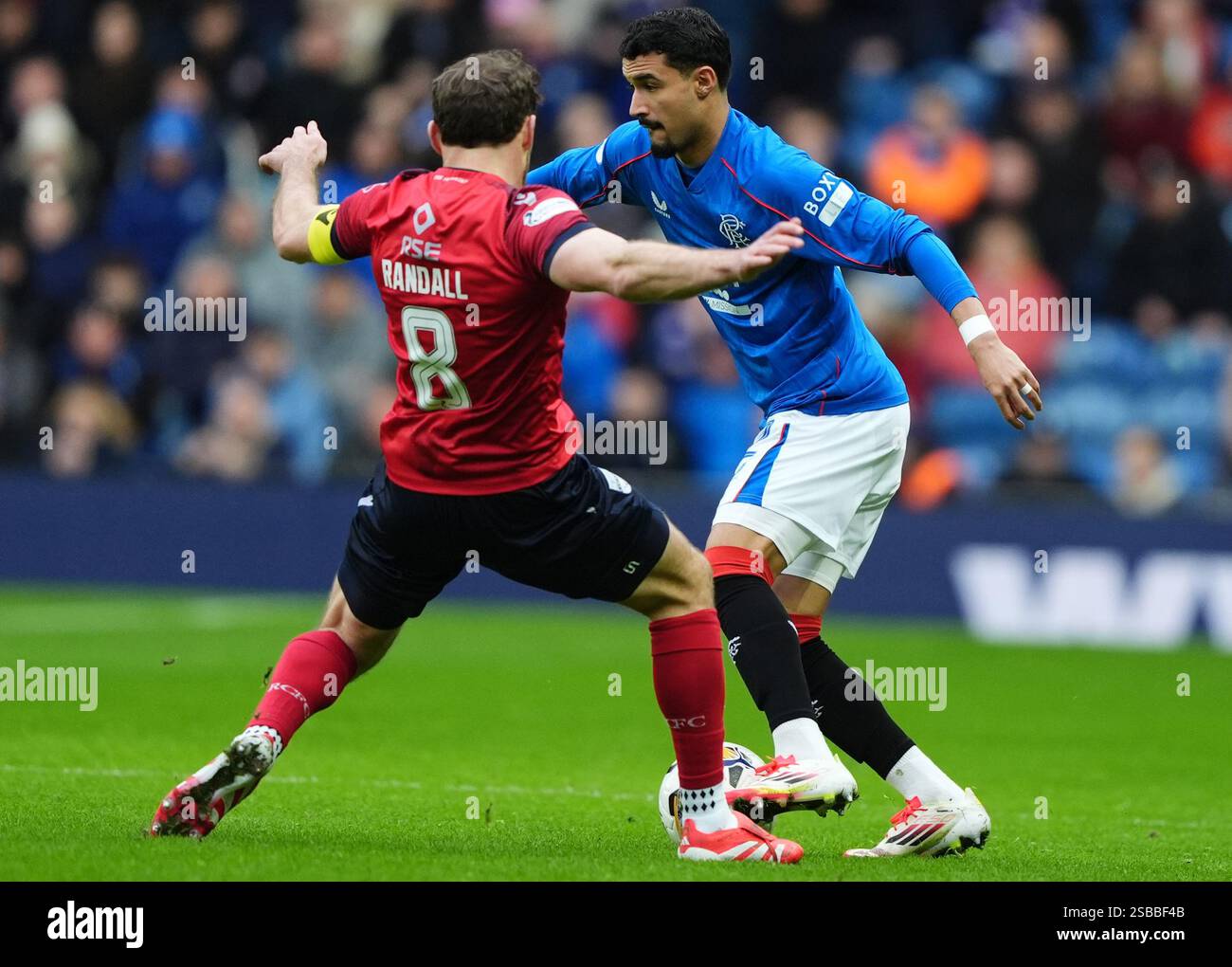 Ross County's Connor Randall (left) and Rangers' Jefte battle for the ...