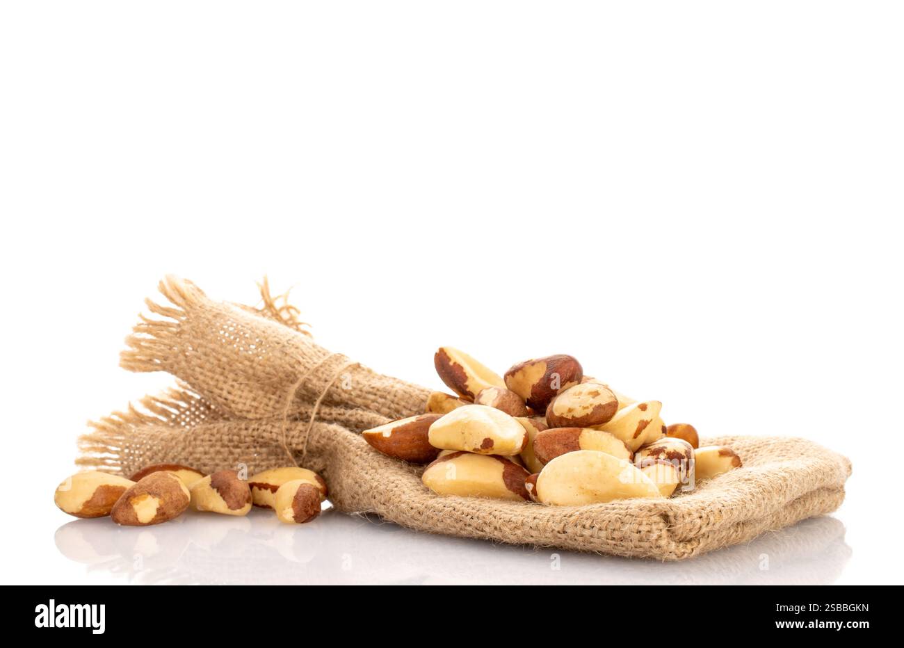 Brazil nuts without shells with jute bag, macro, isolated on white ...