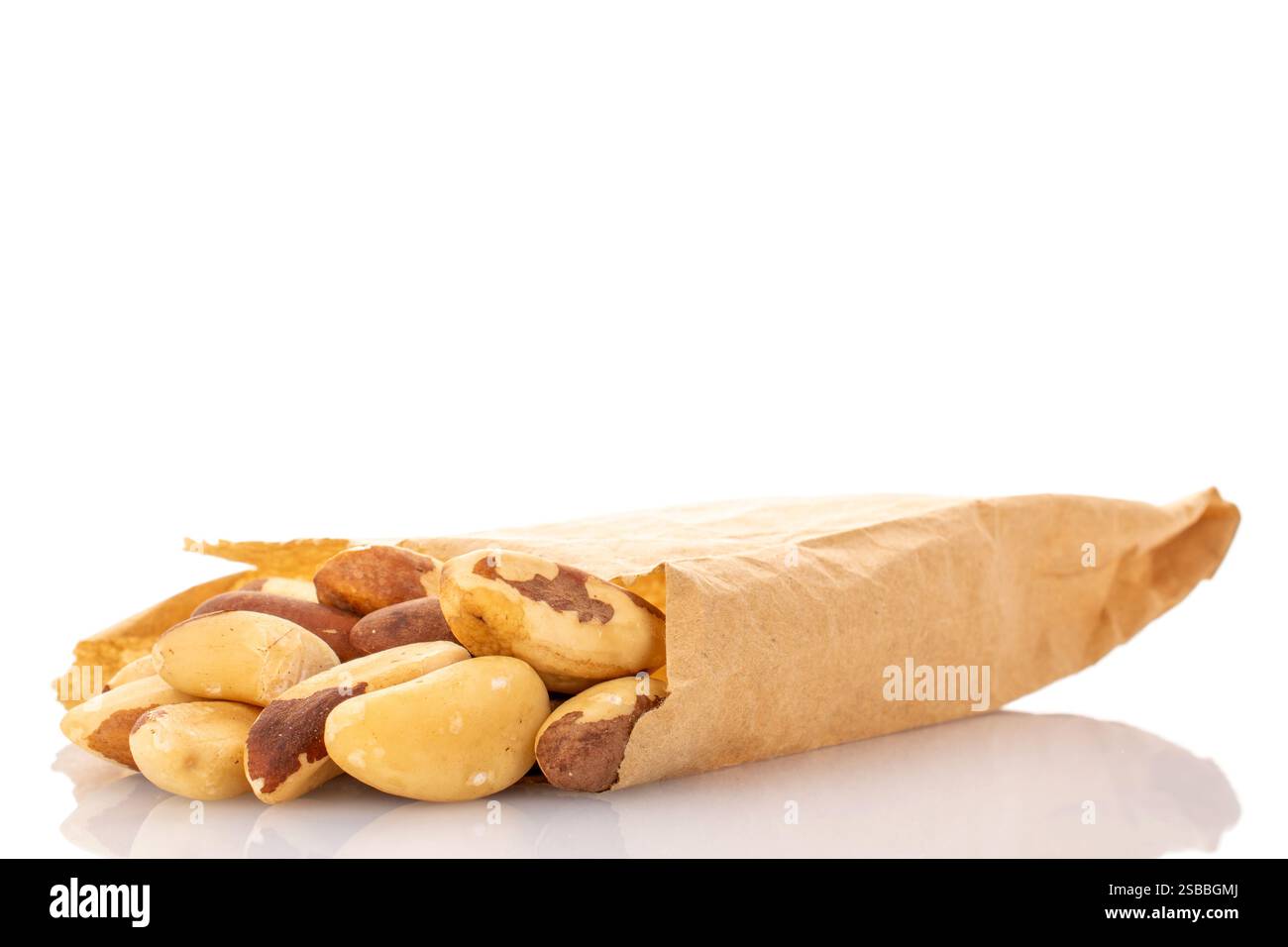 Brazil nuts without shells with paper bag, macro, isolated on white ...