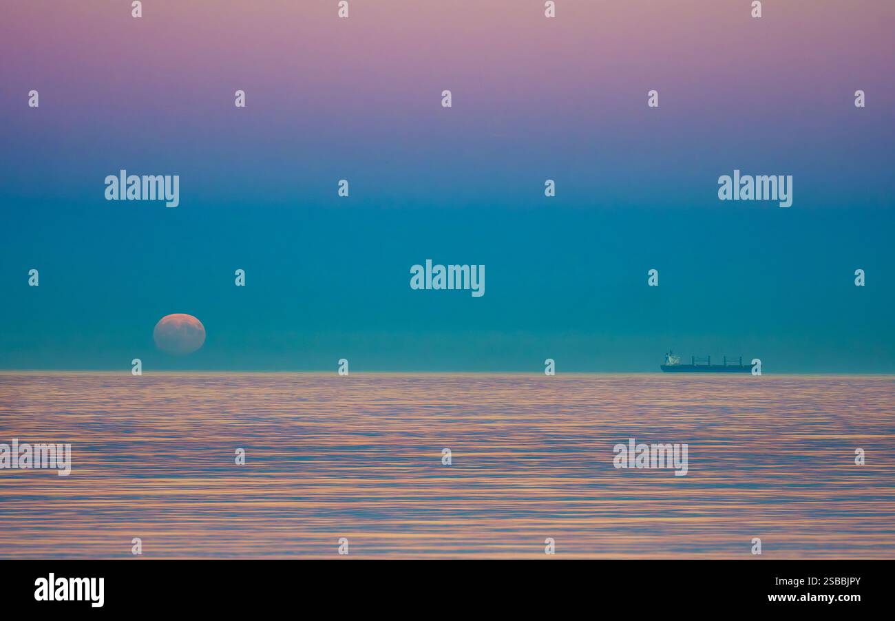 The rising of the Harvest Moon above a hazy Irish Sea horizon Stock ...