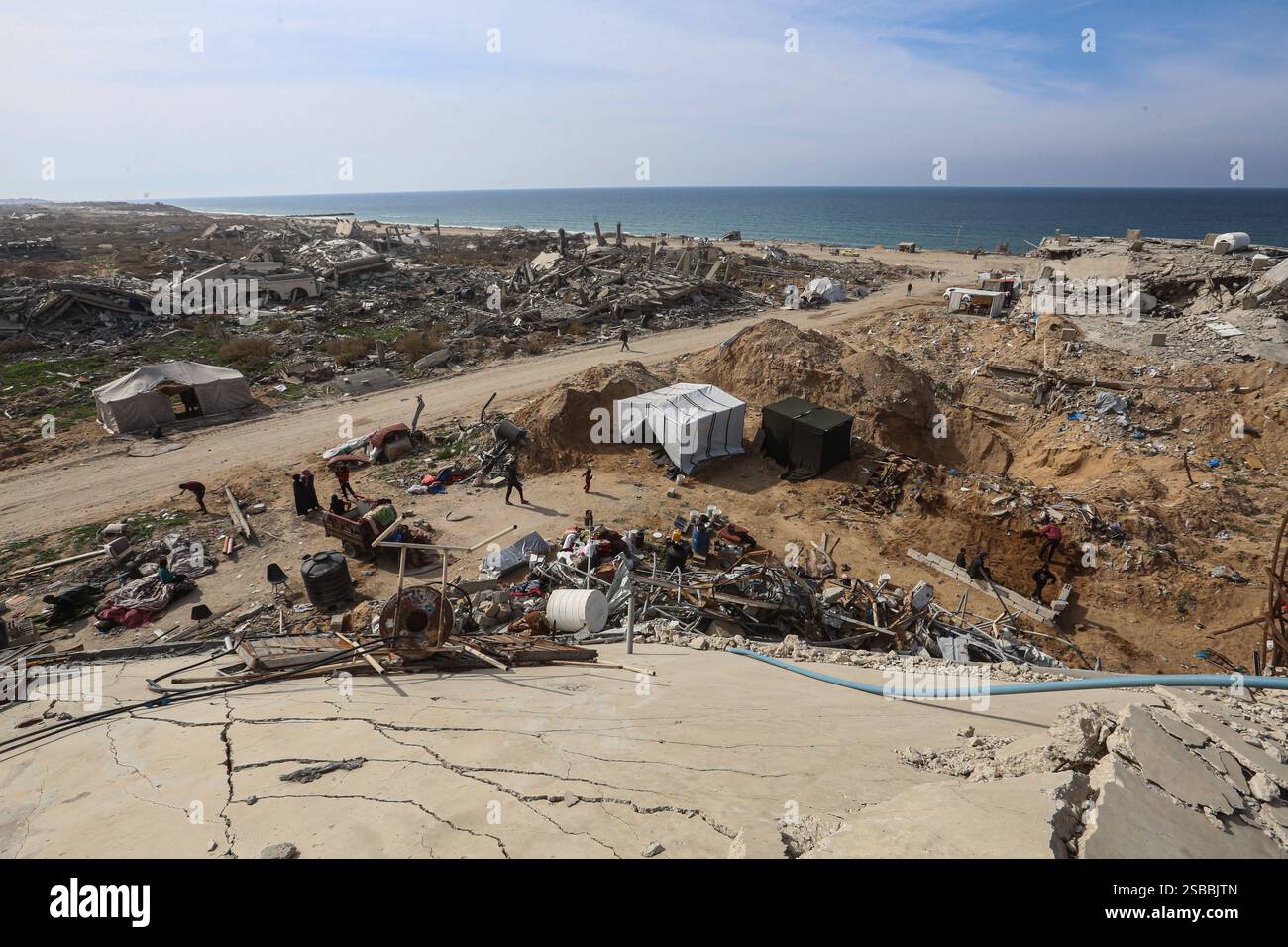 Palestinians try to survive in tents they set up among the debris of ...