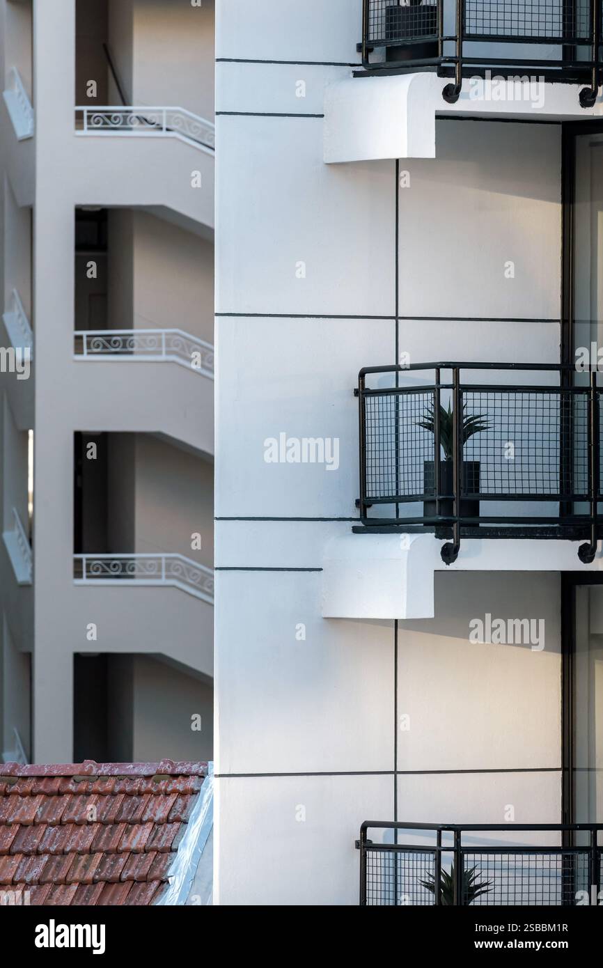 Minimalist balcony extends from a modern, white building. Balcony made ...