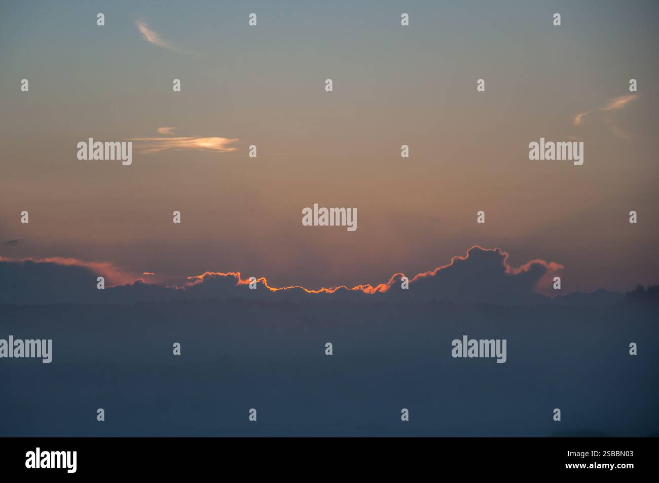 Rising sun coloring the edges of clouds Stock Photo - Alamy