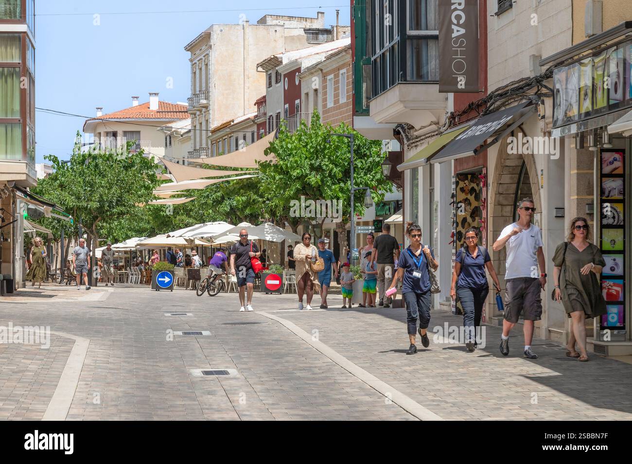 People walk through the cozy streets in the town of Mahón on the island ...