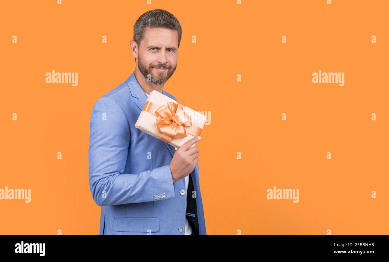 positive guy hold present box in studio. guy with present box for ...