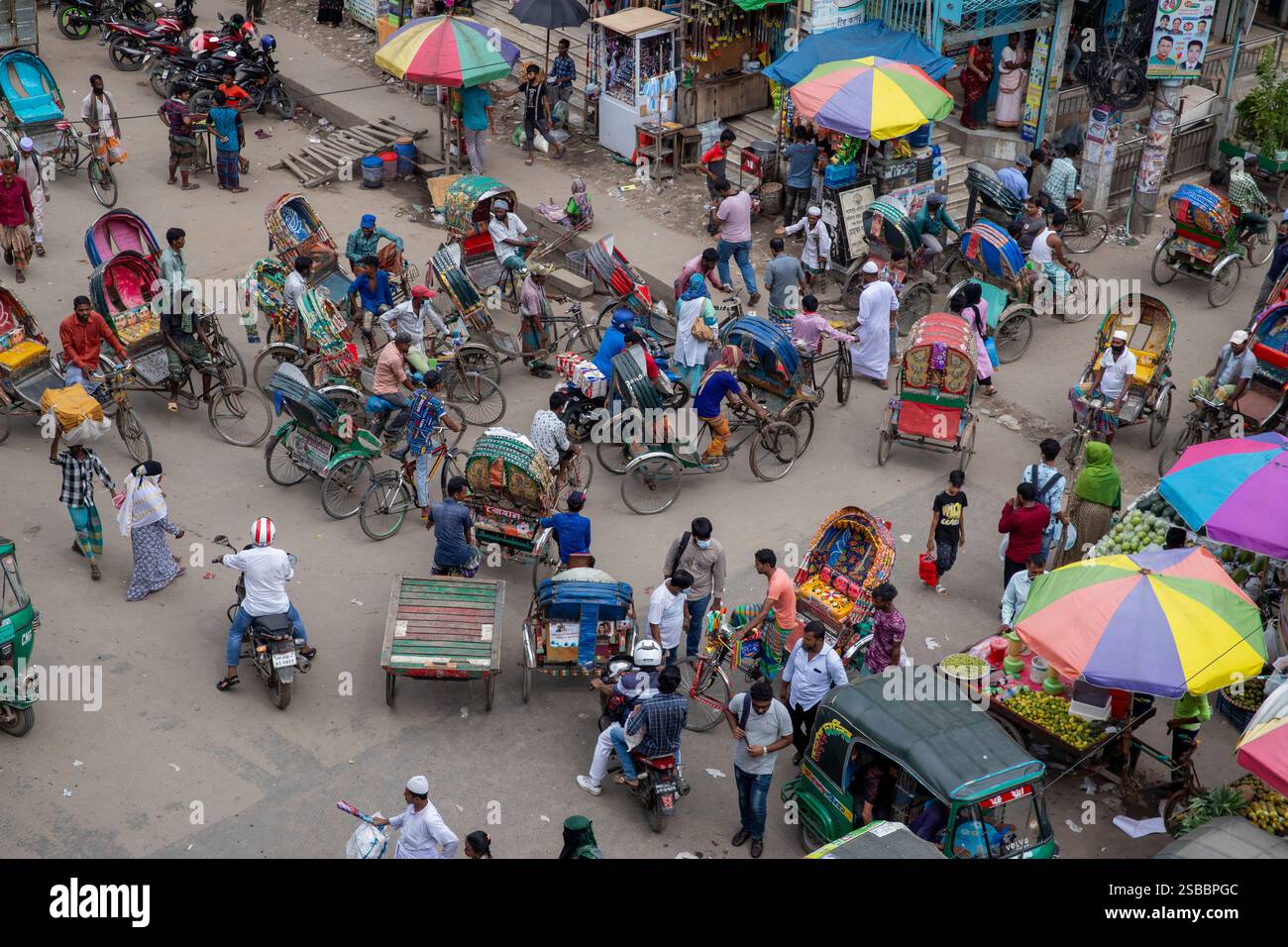A busy road in Jurain, Dhaka, Bangladesh, filled with a crowd of ...
