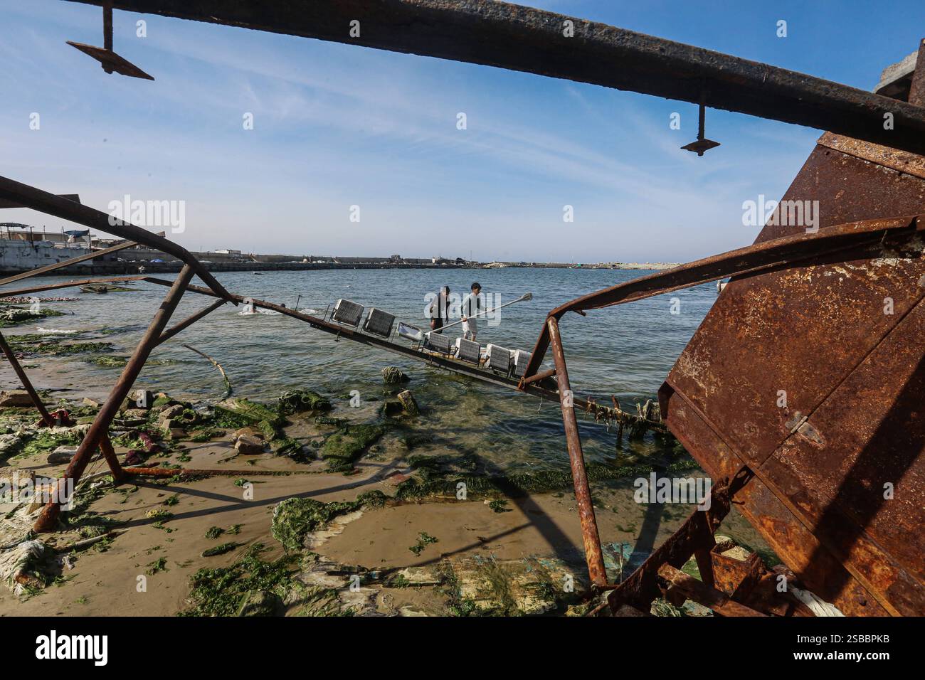 Fishermen paddle on makeshift boats with destroyed buildings seen in ...