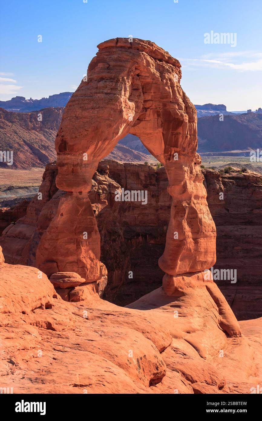 A large archway is carved into the side of a cliff. The archway is ...