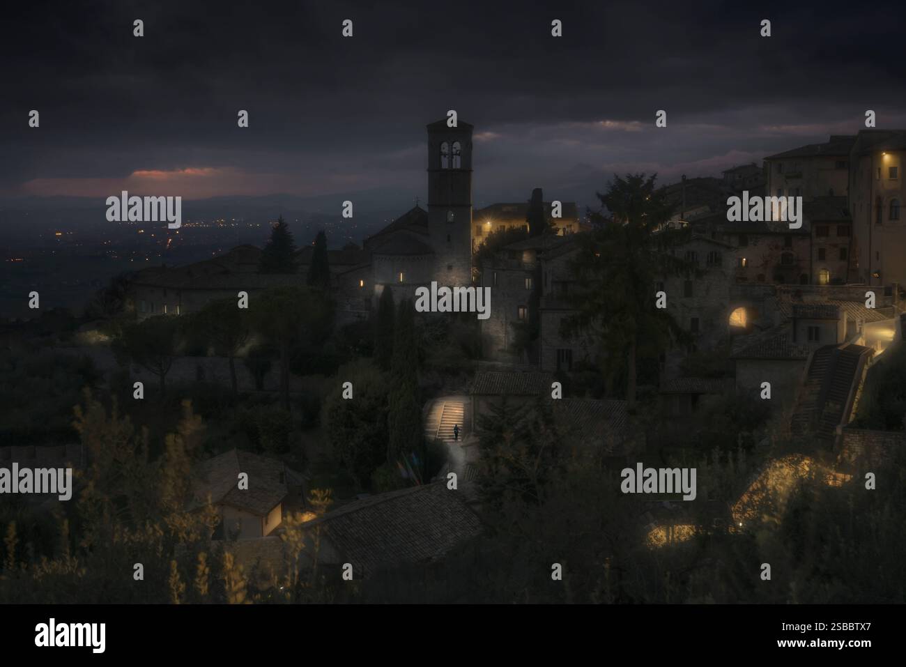 A mesmerizing nighttime view of Assisi, Italy, with its historic stone ...