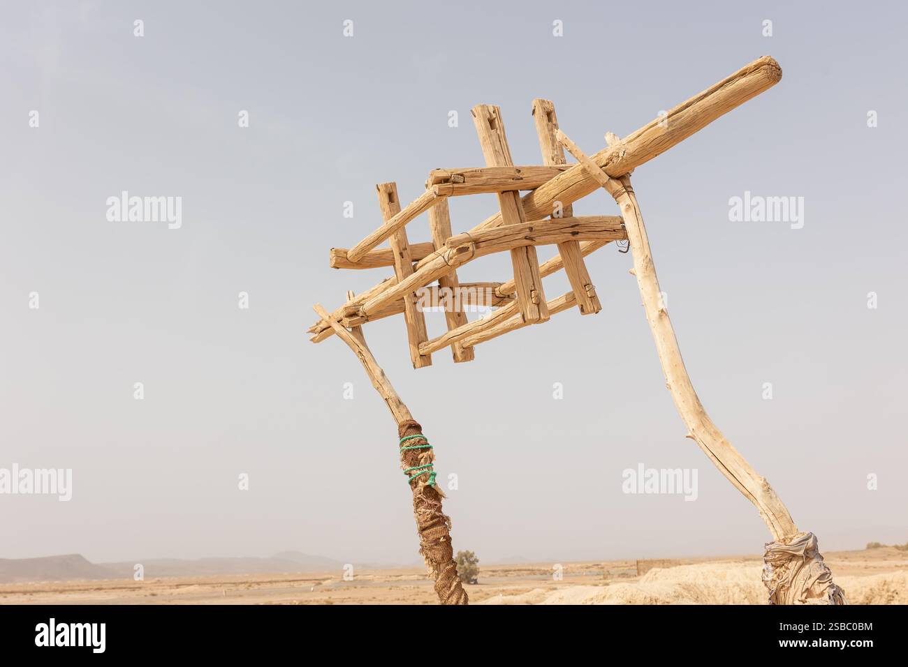 Wooden structure of an old water well against a clear sky. Western ...