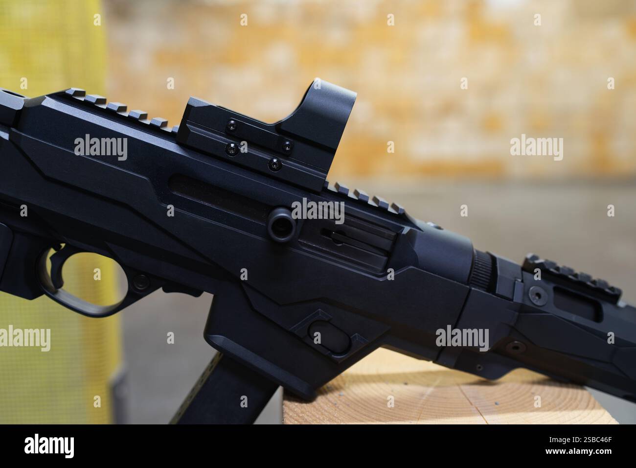 Modern tactical red dot sight mounted on a carbine with a picatinny ...