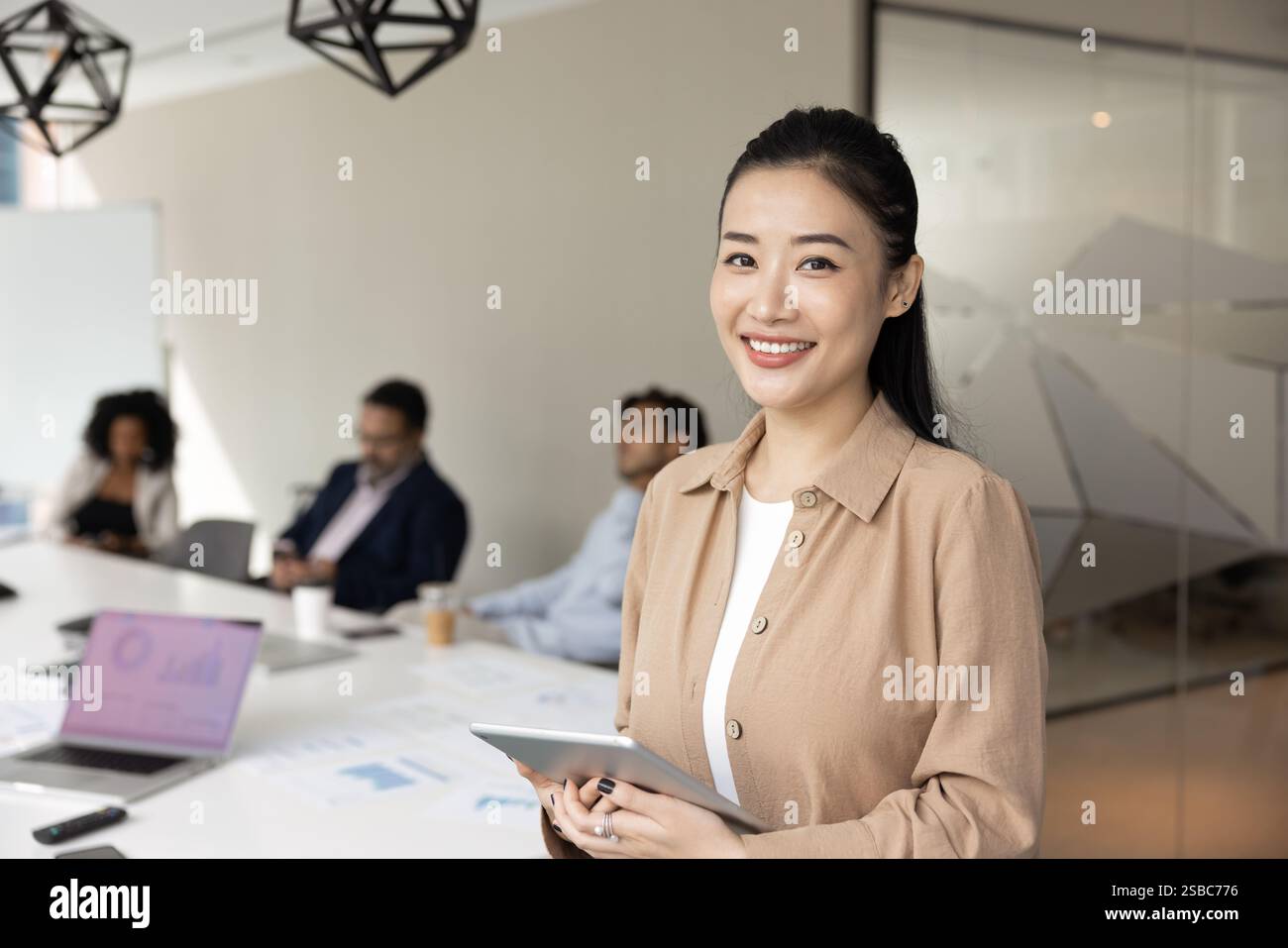 Happy beautiful young Asian project leader woman posing for portrait ...