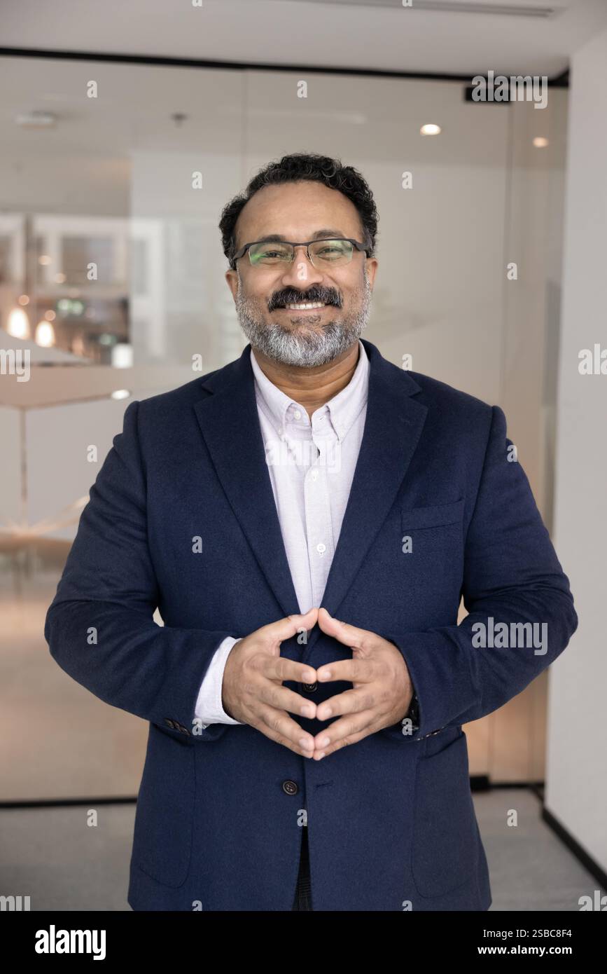 Happy positive mature Indian business leader man vertical portrait ...
